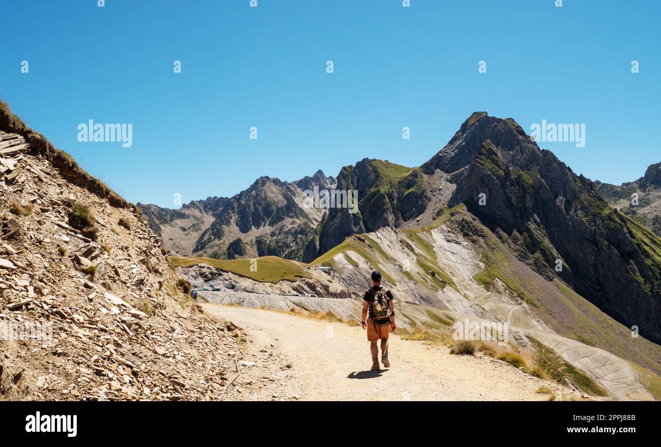 hiker walking at path of Pic du Midi de Bigorre in french Pyrenees ...