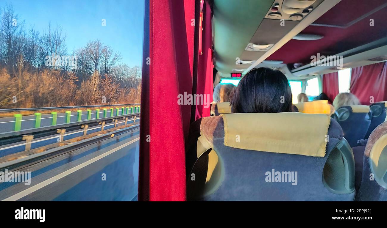 Group of tourist sitting in the bus and looking through the bus windows ...