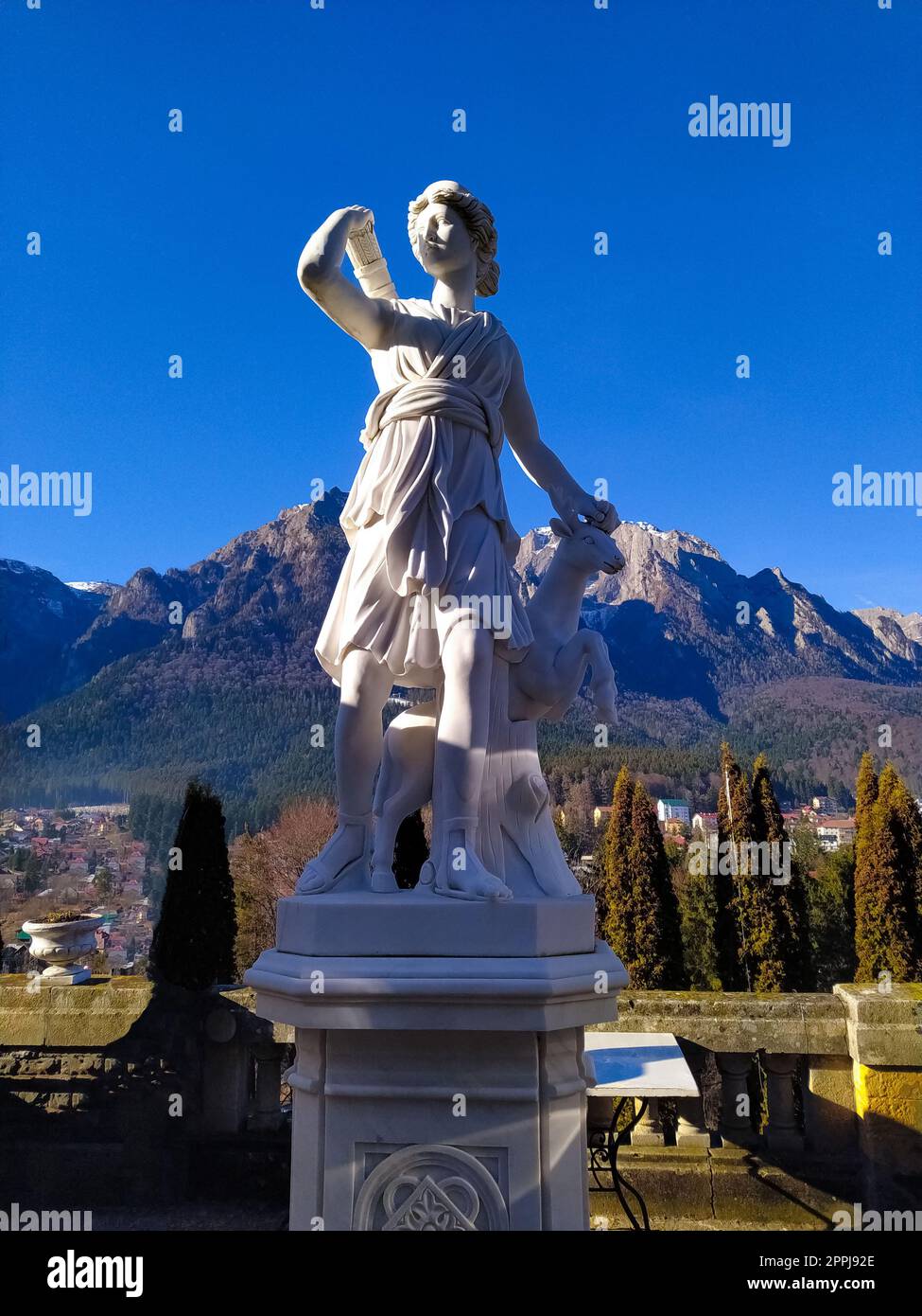 Classic white marble statuette Diana statue isolated on blue sky ...