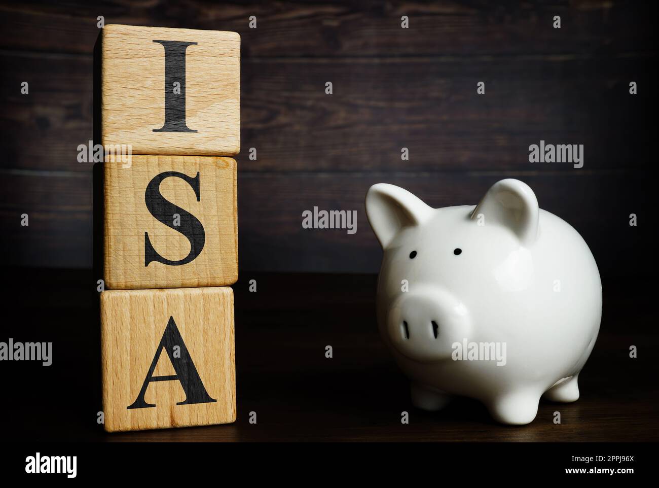 Wooden cubes with letters and piggy bank ISA Individual Savings Account ...