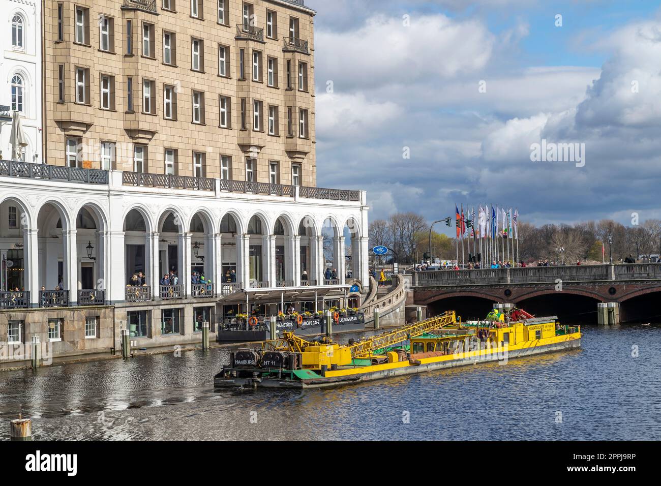 Yellow barge going down little alster infront of Alster Arcades ...