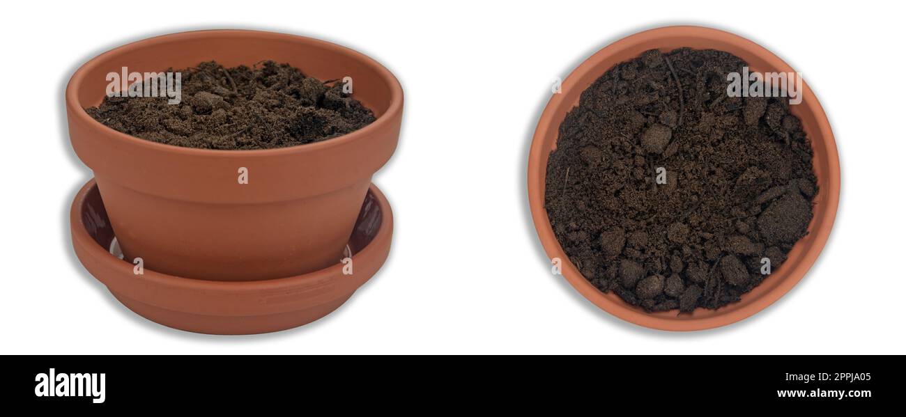 Soil in brown clay plant pot with saucer isolated on a white background ...