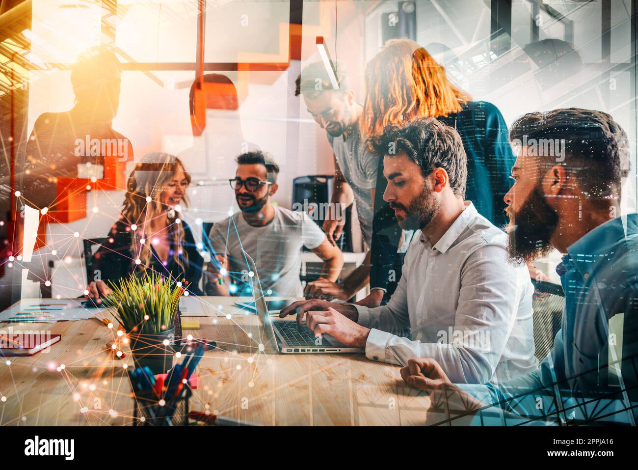 Business people in office work together during a meeting with laptop ...