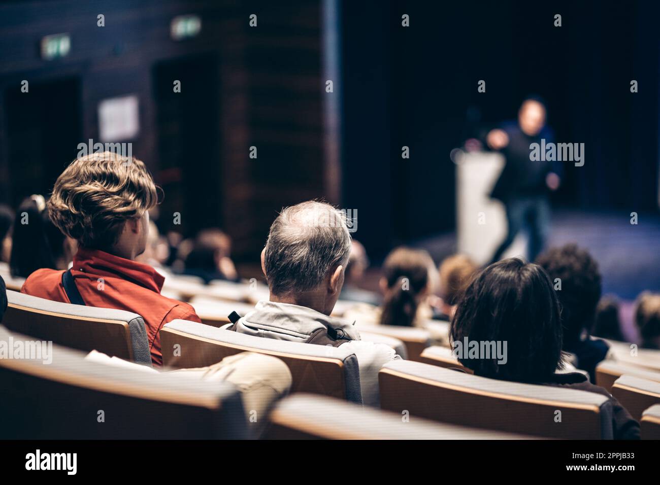 Speaker giving a talk in conference hall at business event. Rear view ...