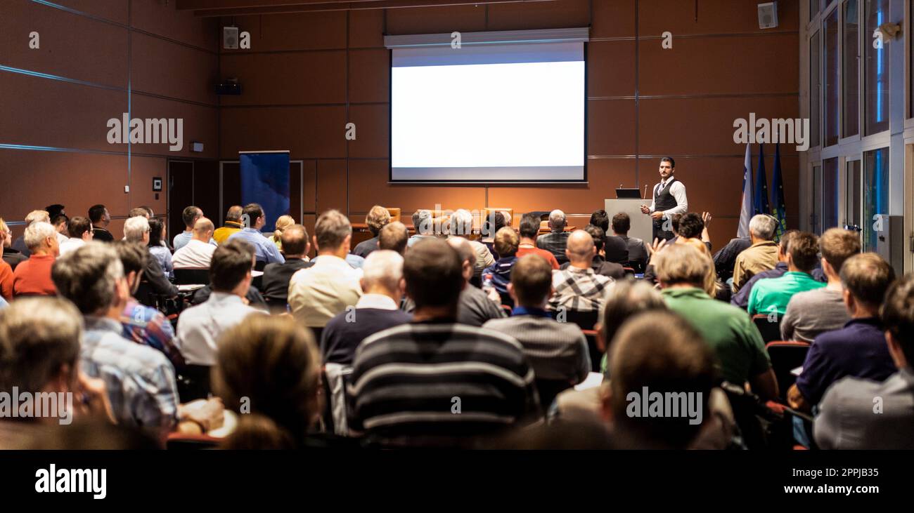 Business speaker giving a talk at business conference meeting event ...