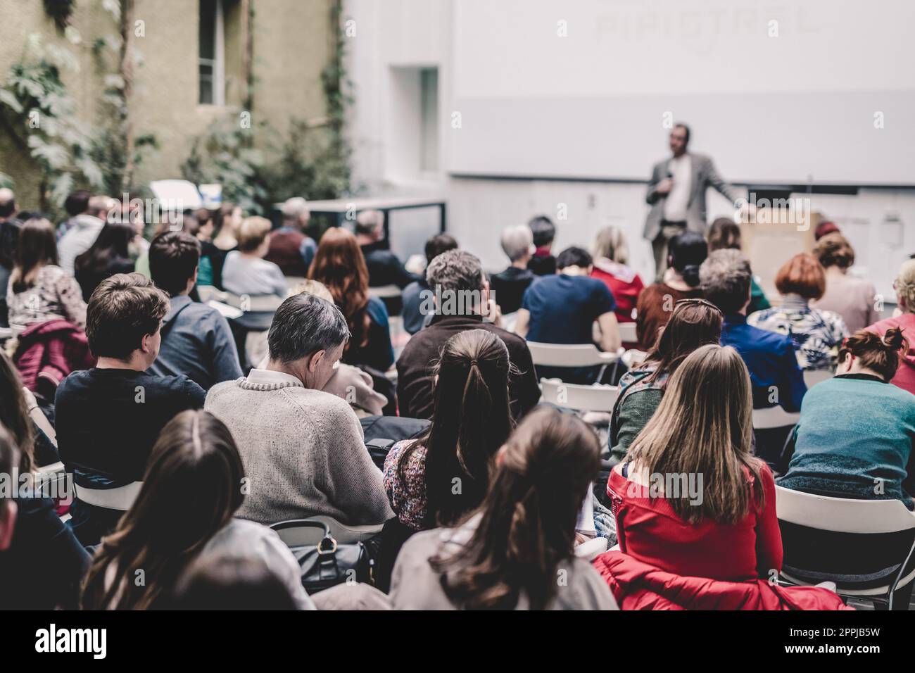 Man giving presentation in lecture hall at university Stock Photo - Alamy