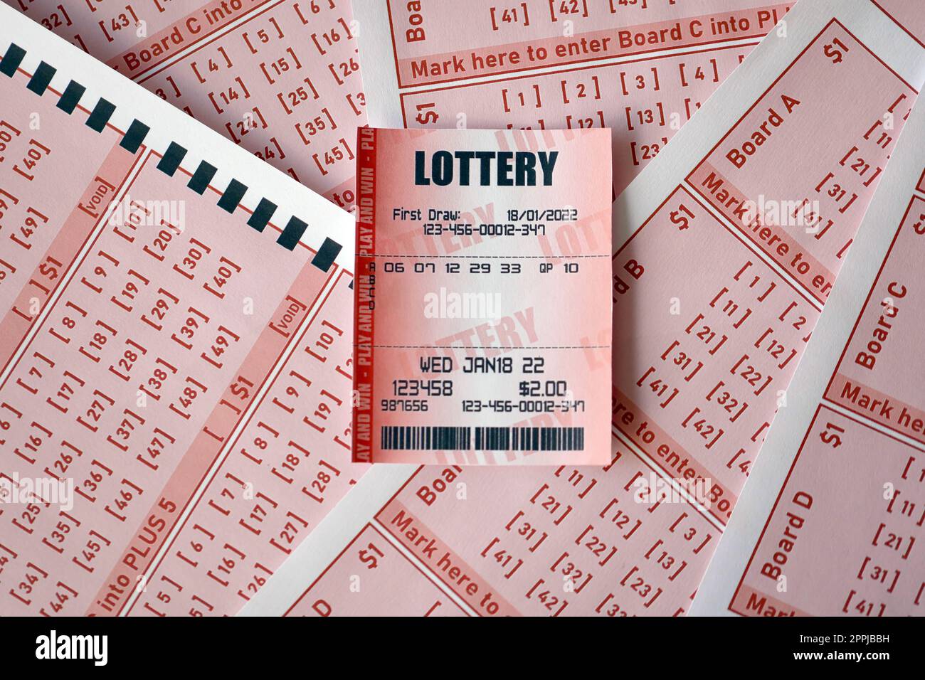 Red lottery ticket lies on pink gambling sheets with numbers for ...
