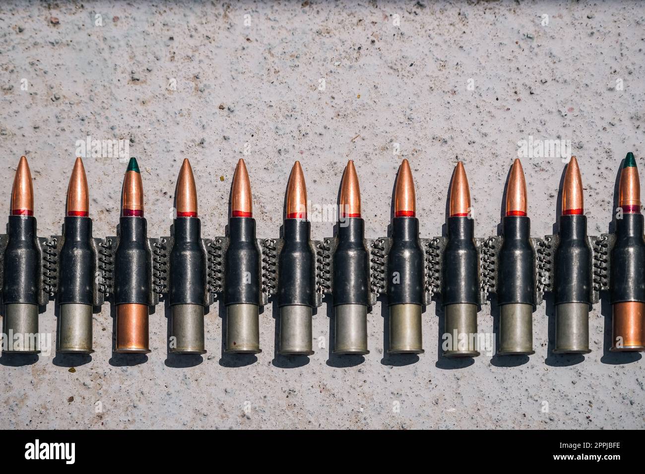 Machine gun belt loaded with cartridges Stock Photo - Alamy