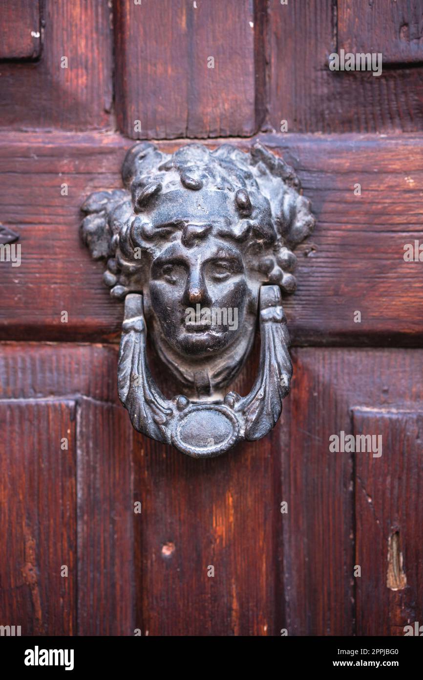 Metal door knocker with a human face Stock Photo - Alamy
