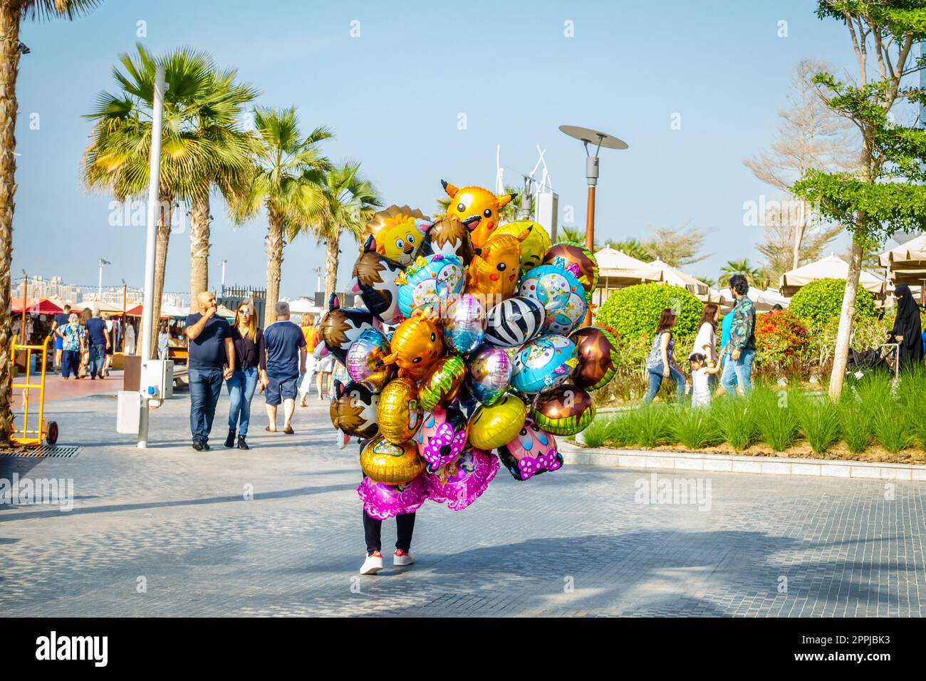 A party balloon vendor on JBR Walk Stock Photo - Alamy