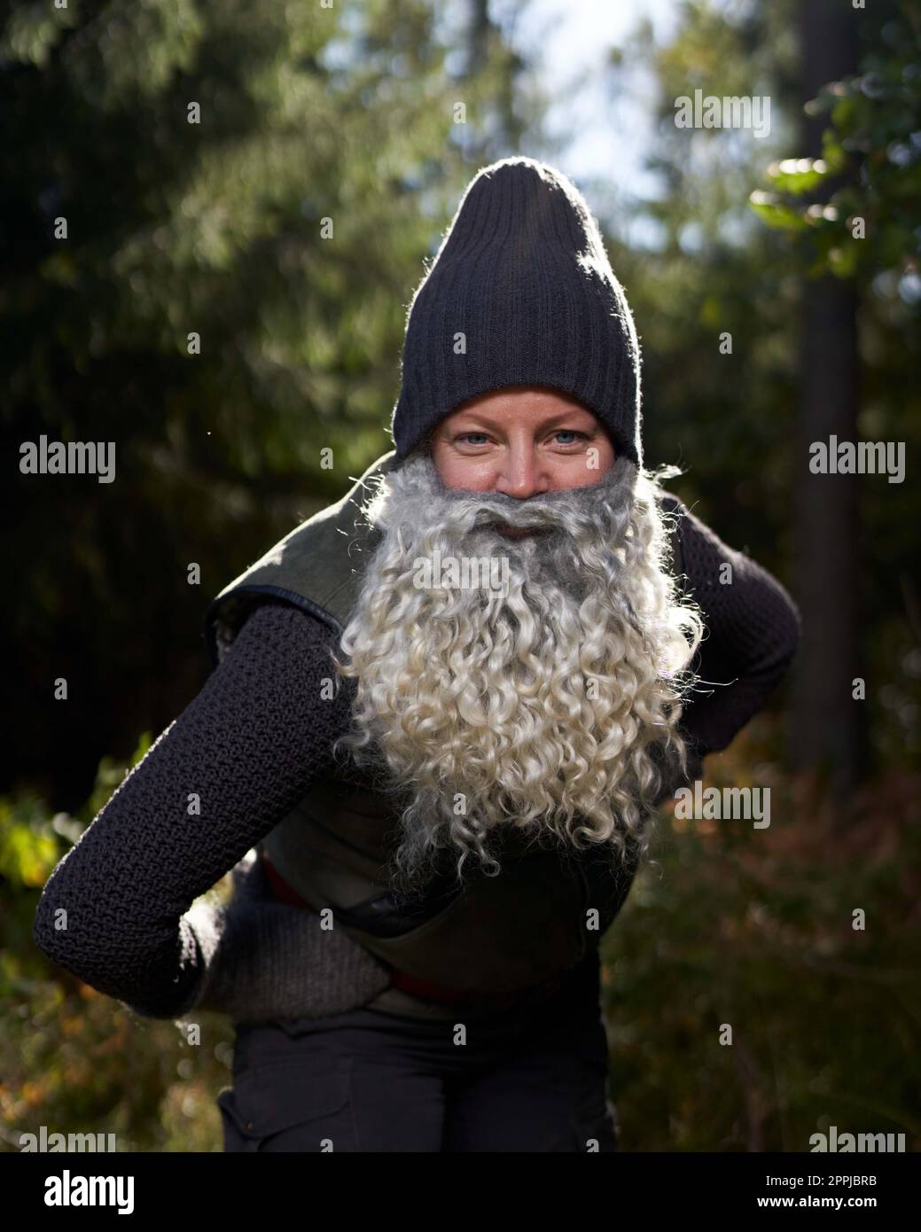 Nordic santa in a grey outfit and big woollen beard Stock Photo - Alamy