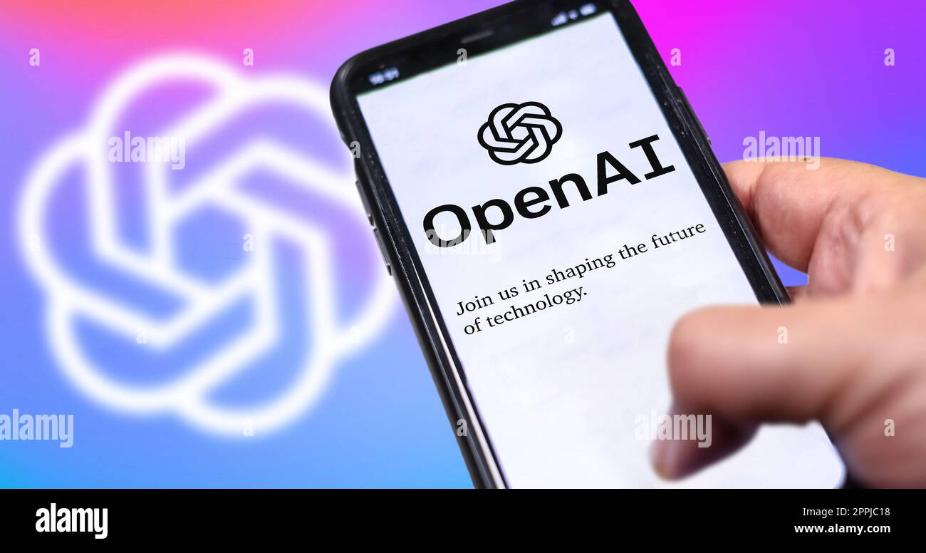 A hand holding a phone with the OpenAI website on the screen Stock ...