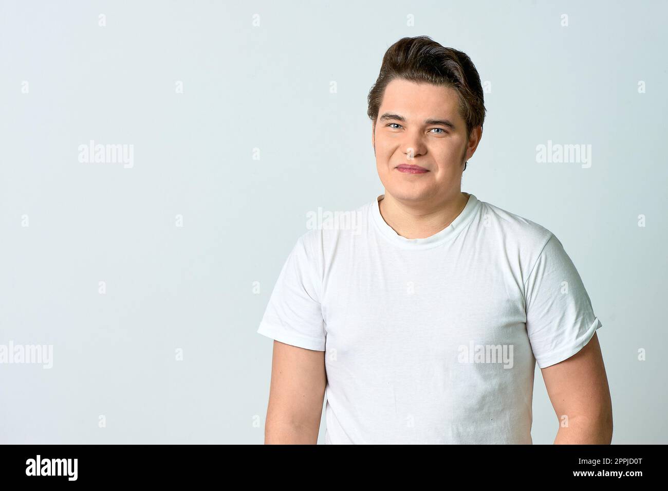A man on a light background smiles. Emotions Stock Photo - Alamy