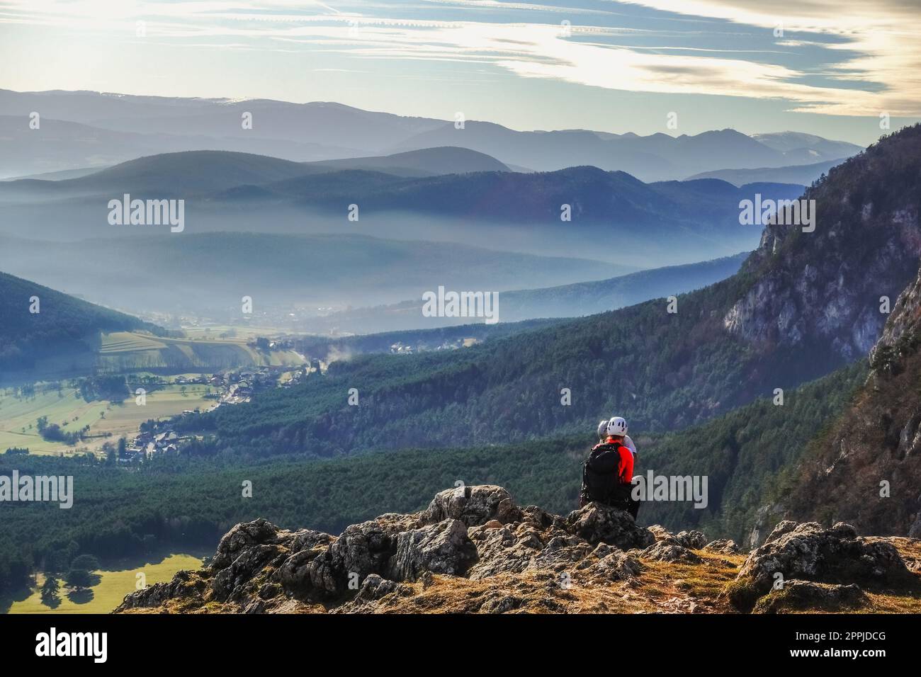 two colorful climber sitting on a rock after the tour Stock Photo - Alamy