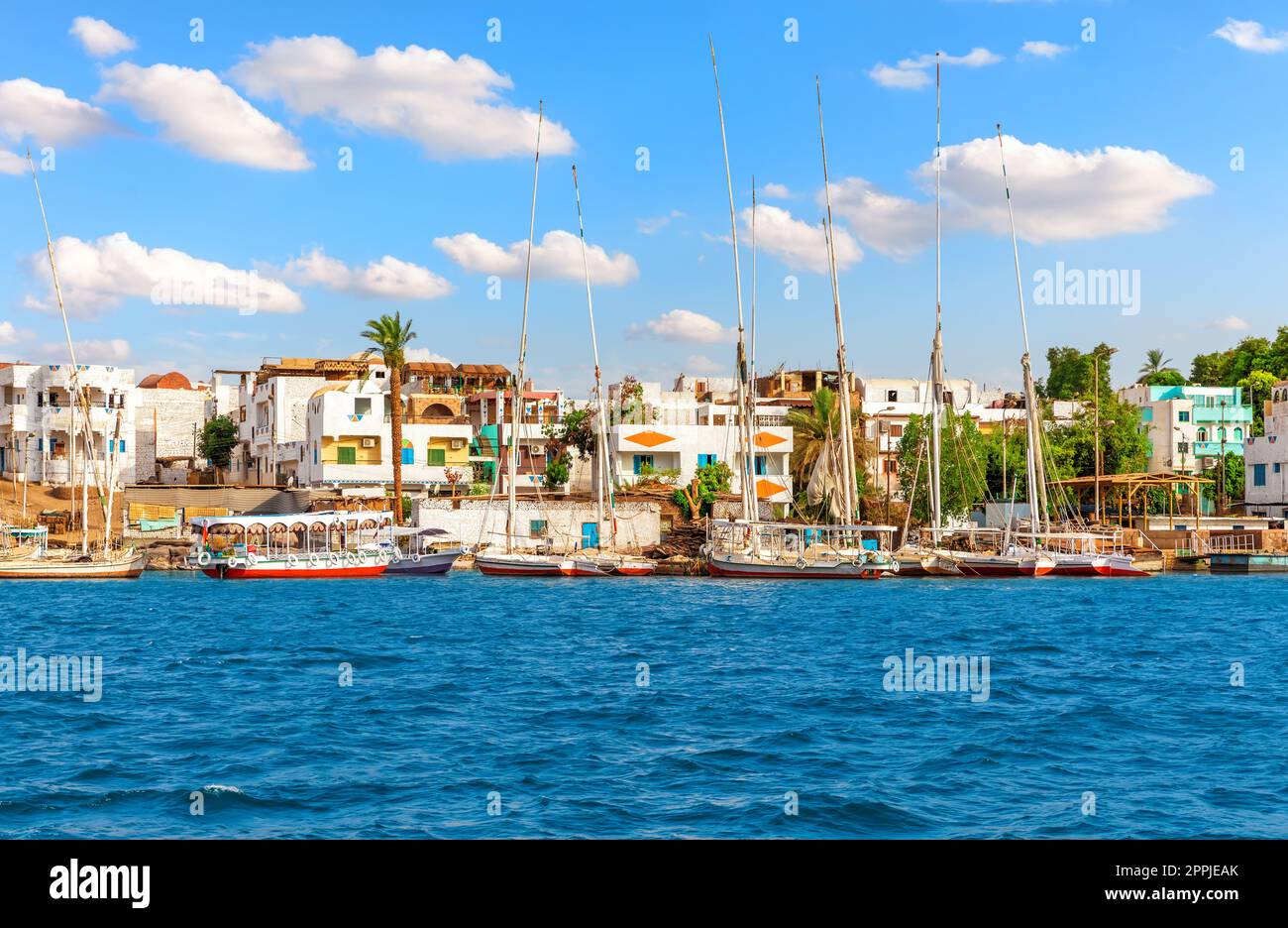 Traditional buildings of Aswan in the Nile and sailboats, Egypt Stock ...