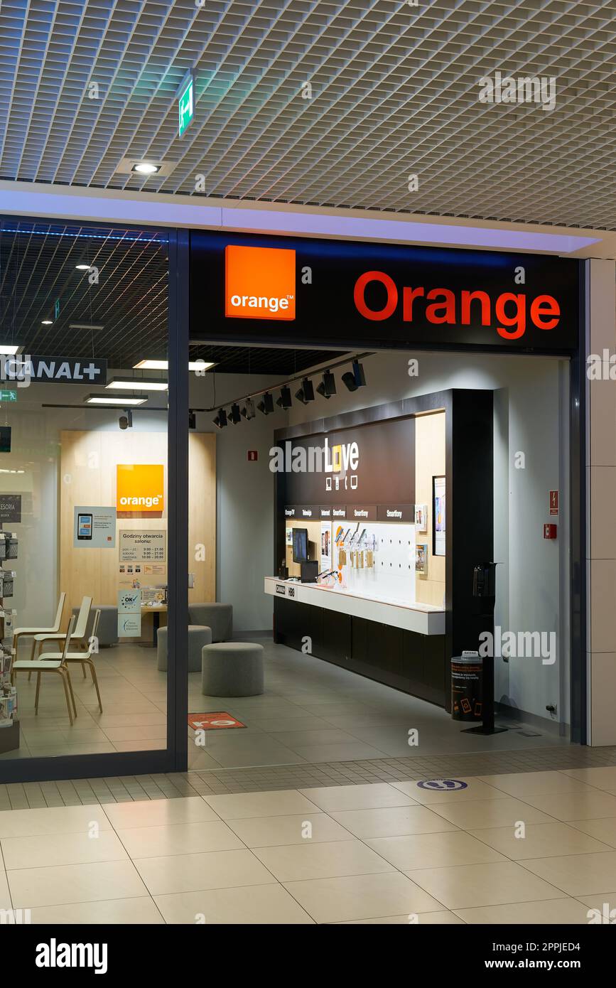 Illuminated sign of the French telecommunication company Orange in a ...