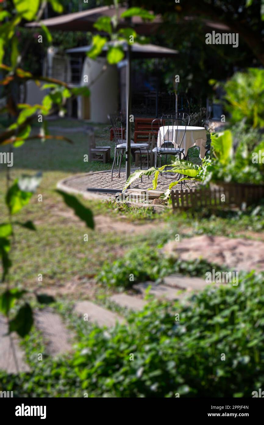 Outdoor seats in green garden Stock Photo - Alamy