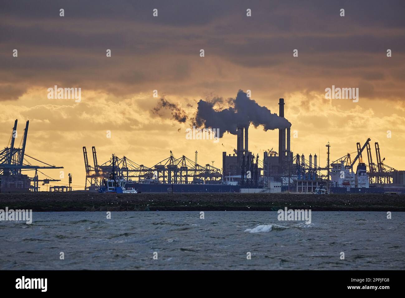 Smoking power plant in industrial port Stock Photo - Alamy
