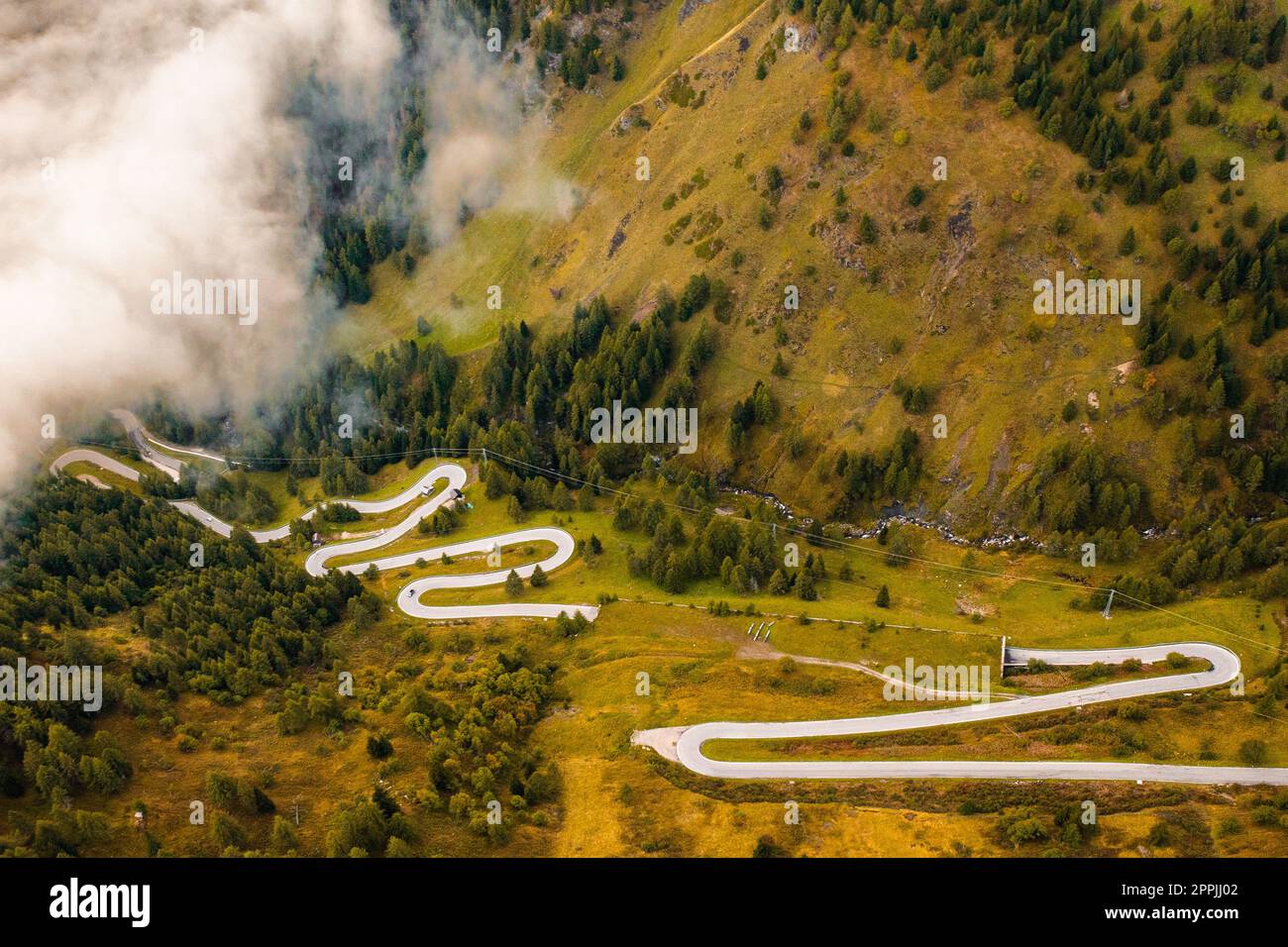 Snake Road winds across coniferous forest of Alpine mountain Stock ...