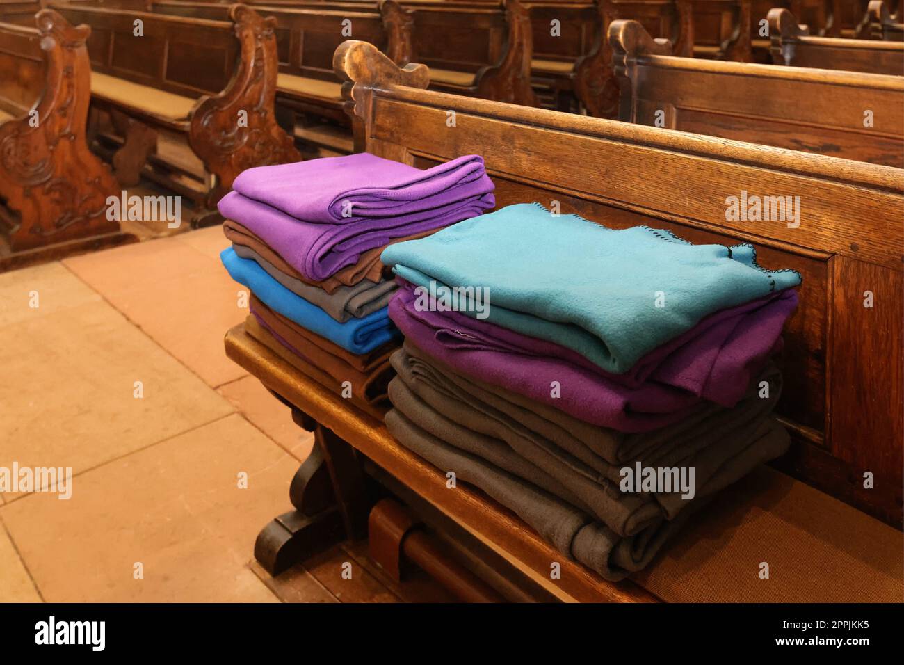 wool blankets on church pews Stock Photo - Alamy