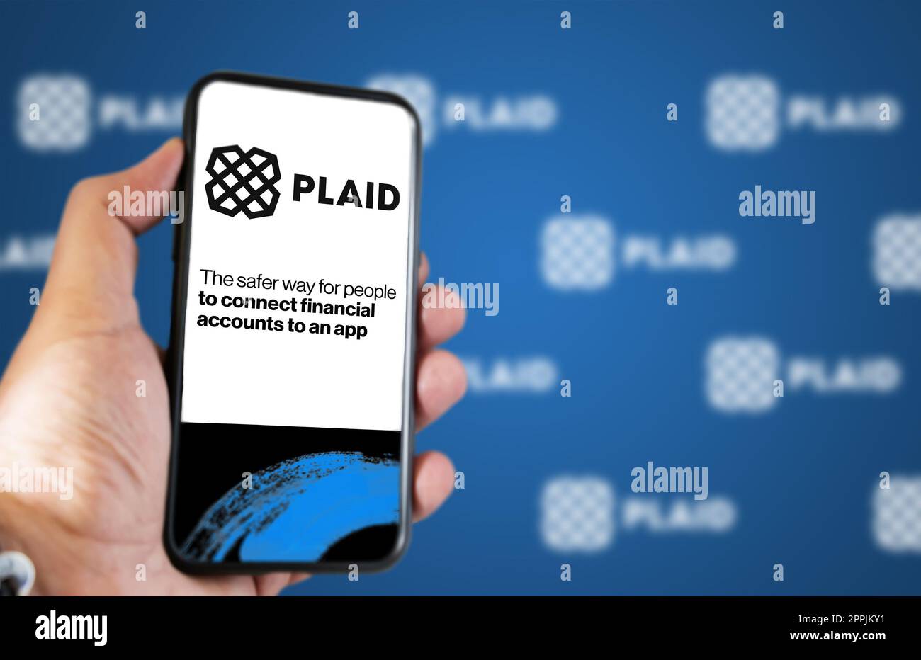 hand holding a phone with Plaid homepage on screen Stock Photo - Alamy