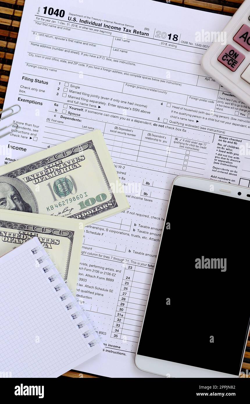 Composition of items lying on the 1040 tax form. Dollar bills ...