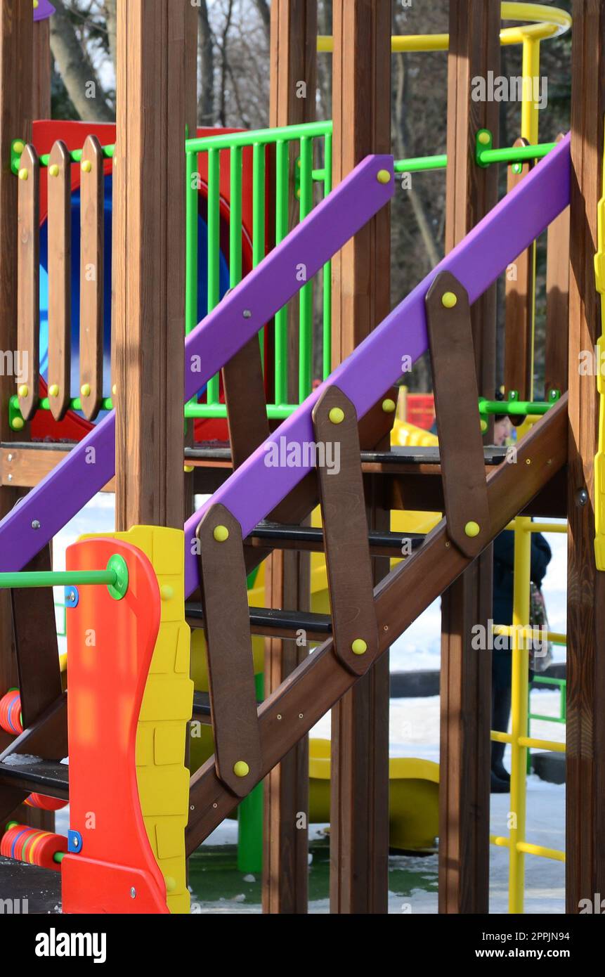Fragment of a playground made of plastic and wood, painted in different ...