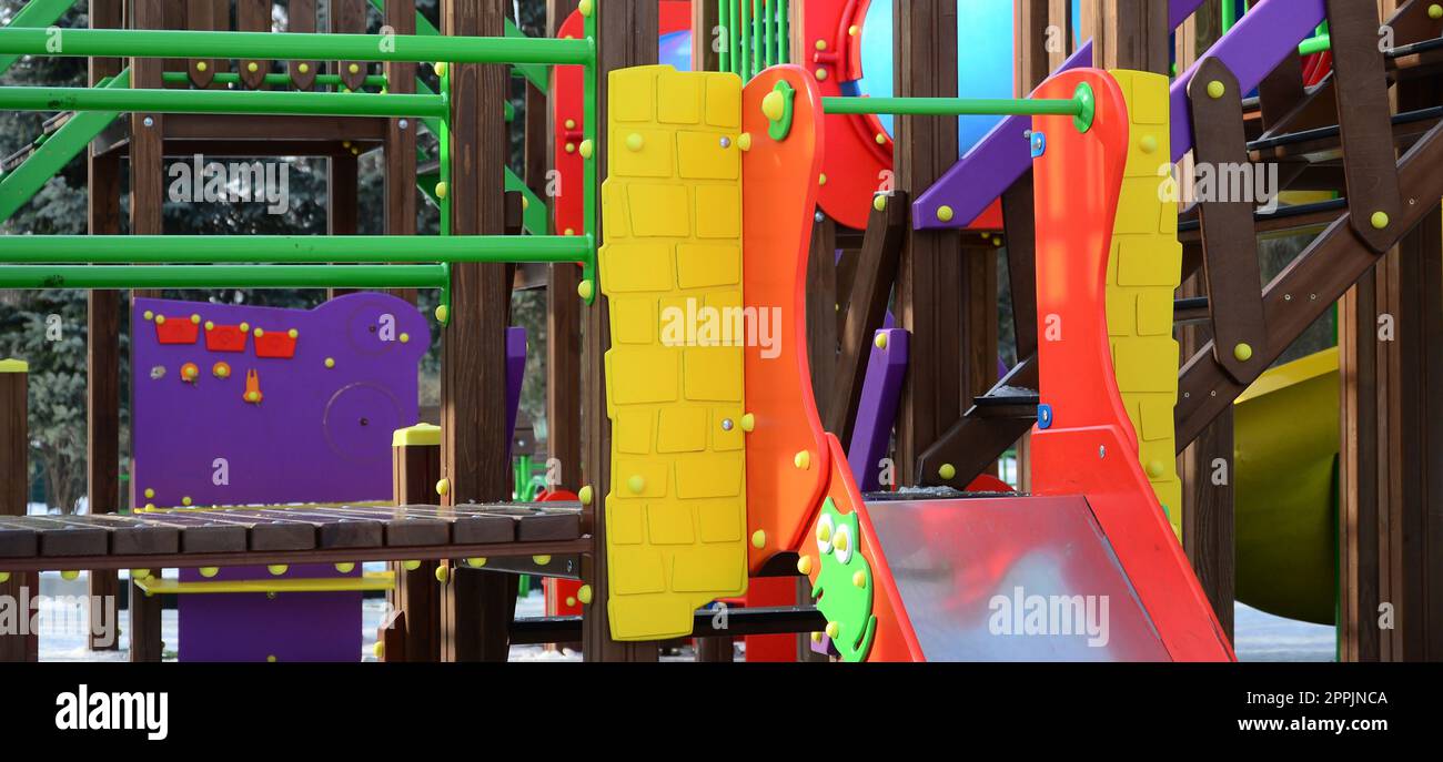 Fragment of a playground made of plastic and wood, painted in different ...