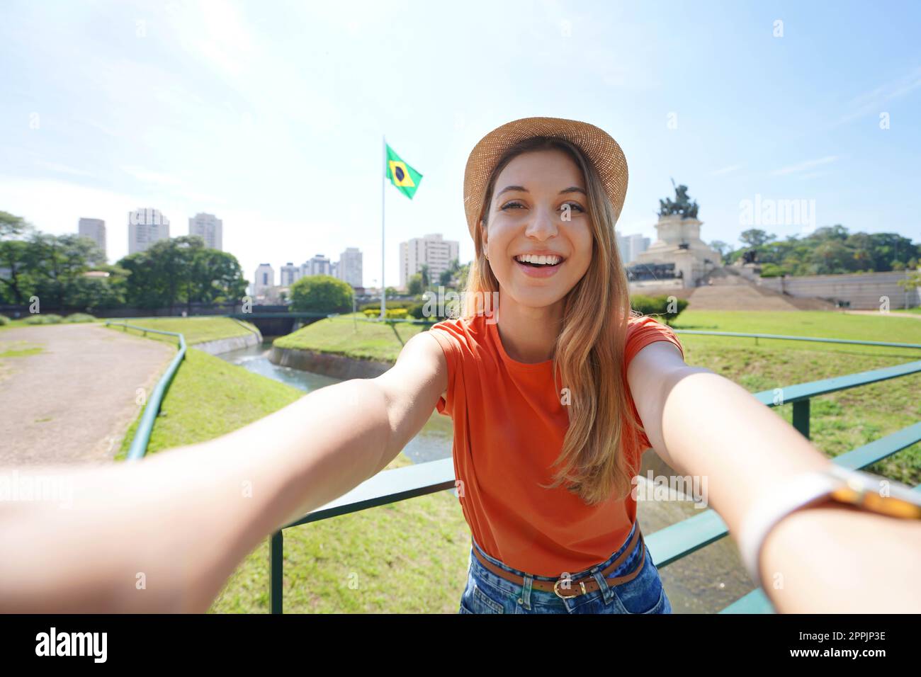 Tourism in Sao Paulo. Beautiful smiling girl takes self portrait in Sao ...