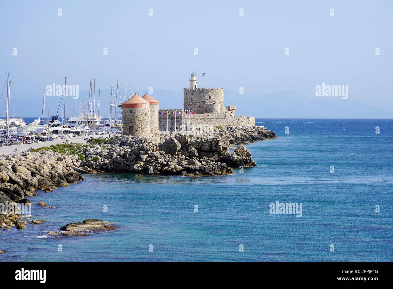Mandraki Marina and port with Rhodes Windmills and Fort of Saint ...