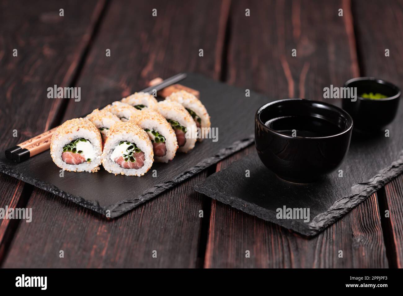 Sushi roll with salmon, green onion and cottage cheese with sesame ...