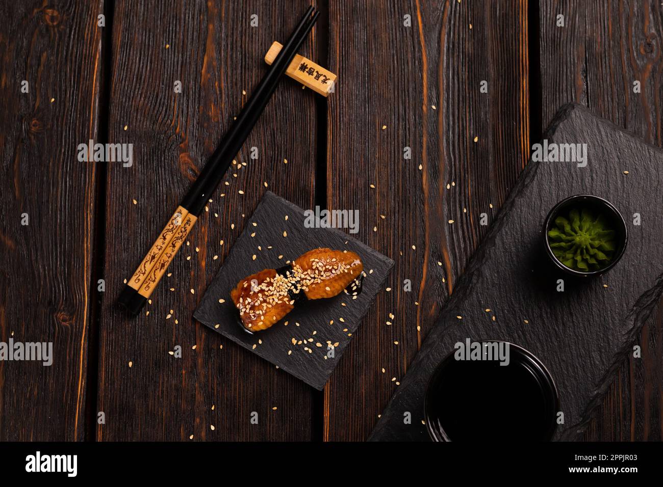 Japanese sushi unagi nigiri sushi smoked eel on wooden background top view Stock Photo - Alamy