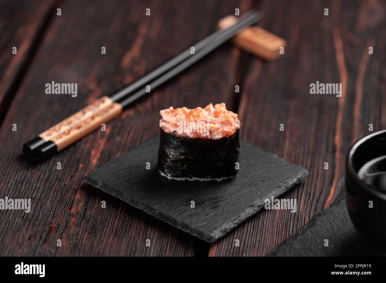 Gunkan Maki Sushi of fish salmon, scallop, perch, eel, shrimp and caviar on wooden table ...