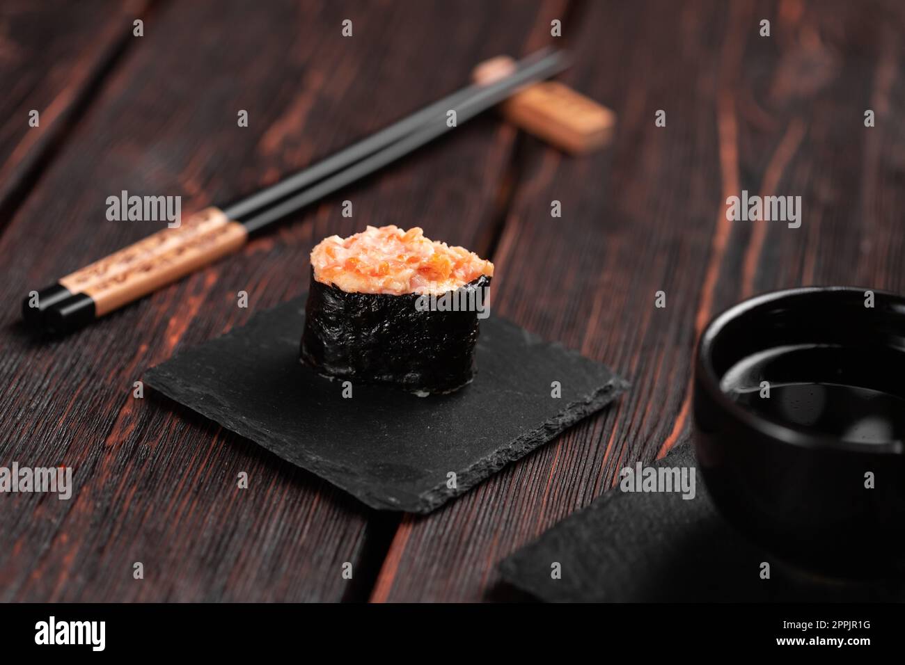 Gunkan Maki Sushi of fish salmon, scallop, perch, eel, shrimp and caviar on wooden table ...