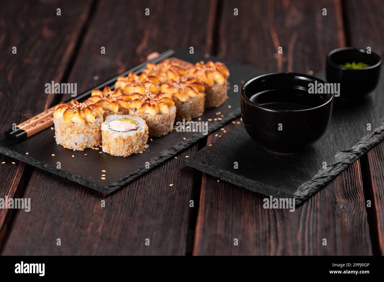 Sushi roll philadelphia with crab avocado and cream cheese on black ...