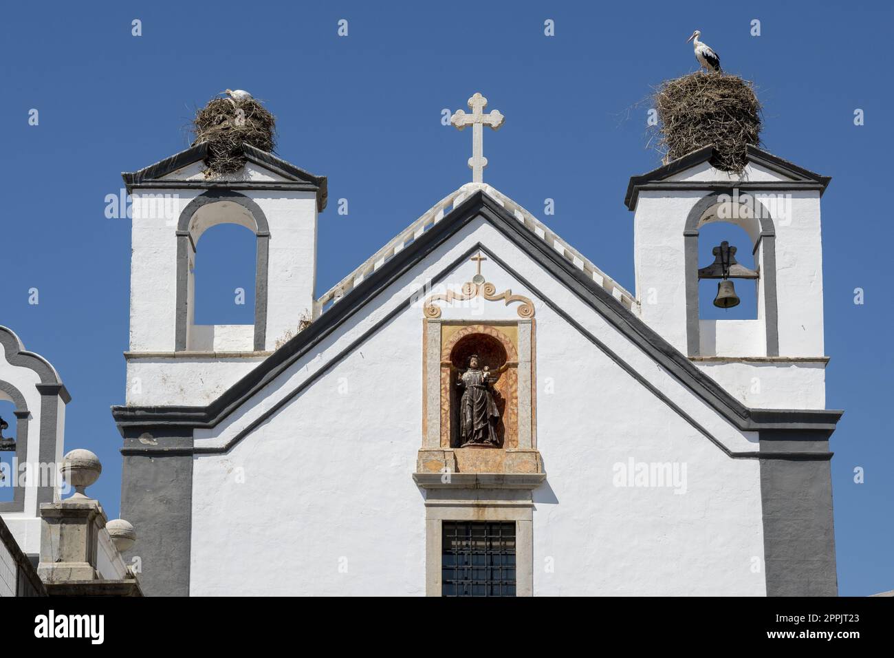 Stork nests on the tower of a Convento de Santo AntÃ³nio dos Capuchos ...