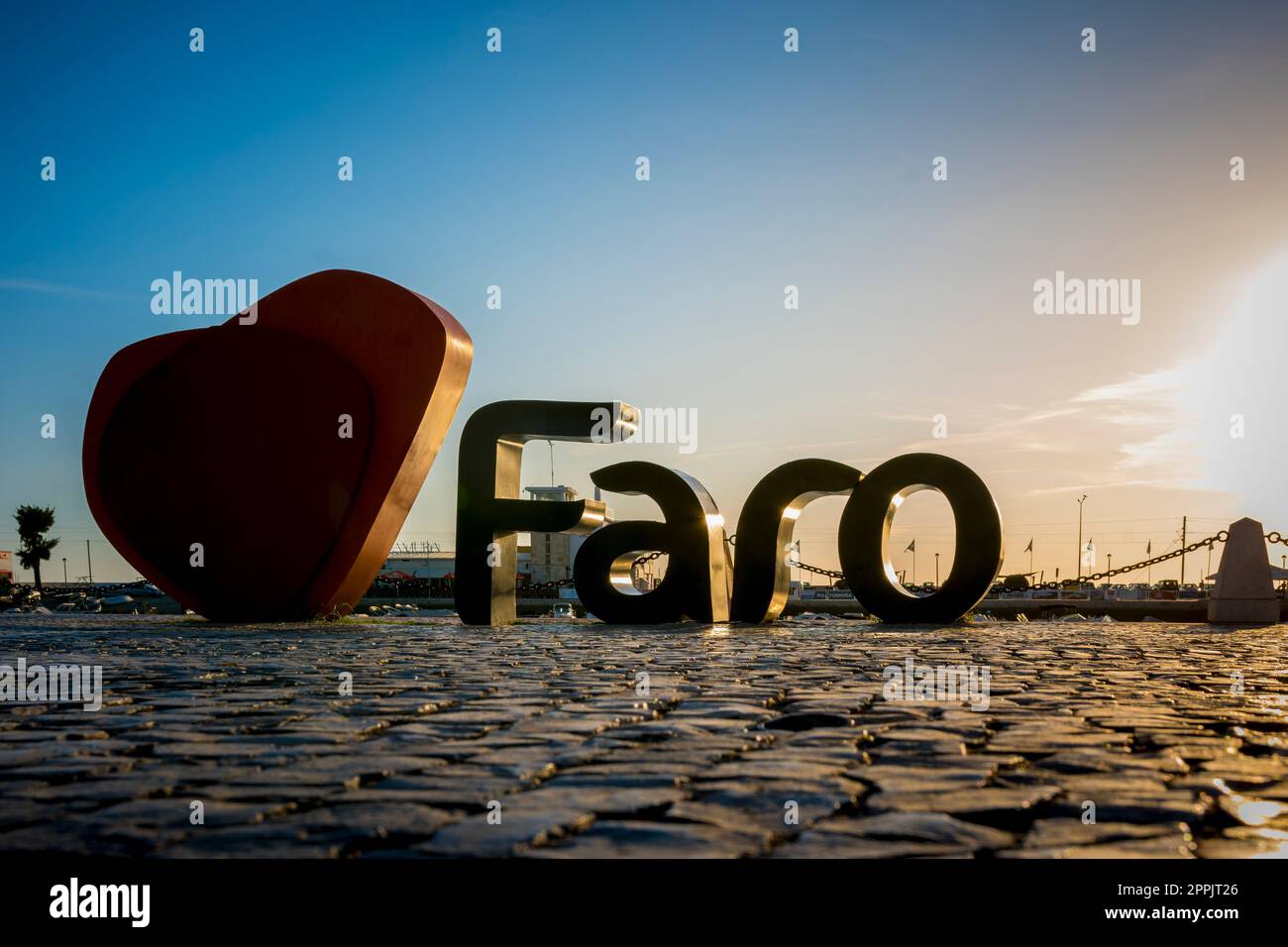 Sunset view on the Faro sign in the harbor of the city Stock Photo - Alamy