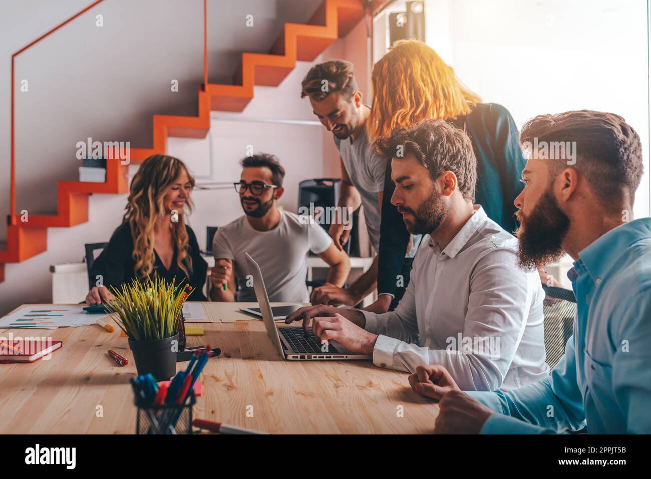 Business people in office work together during a meeting with laptop ...