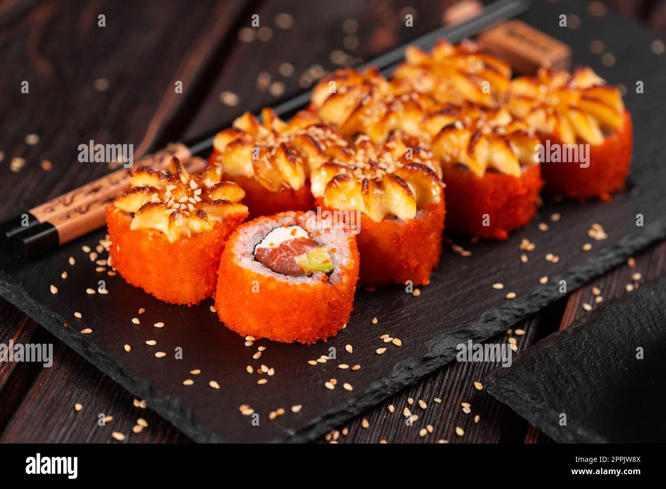 California sushi roll with salmon, avocado and tobiko caviar served on ...