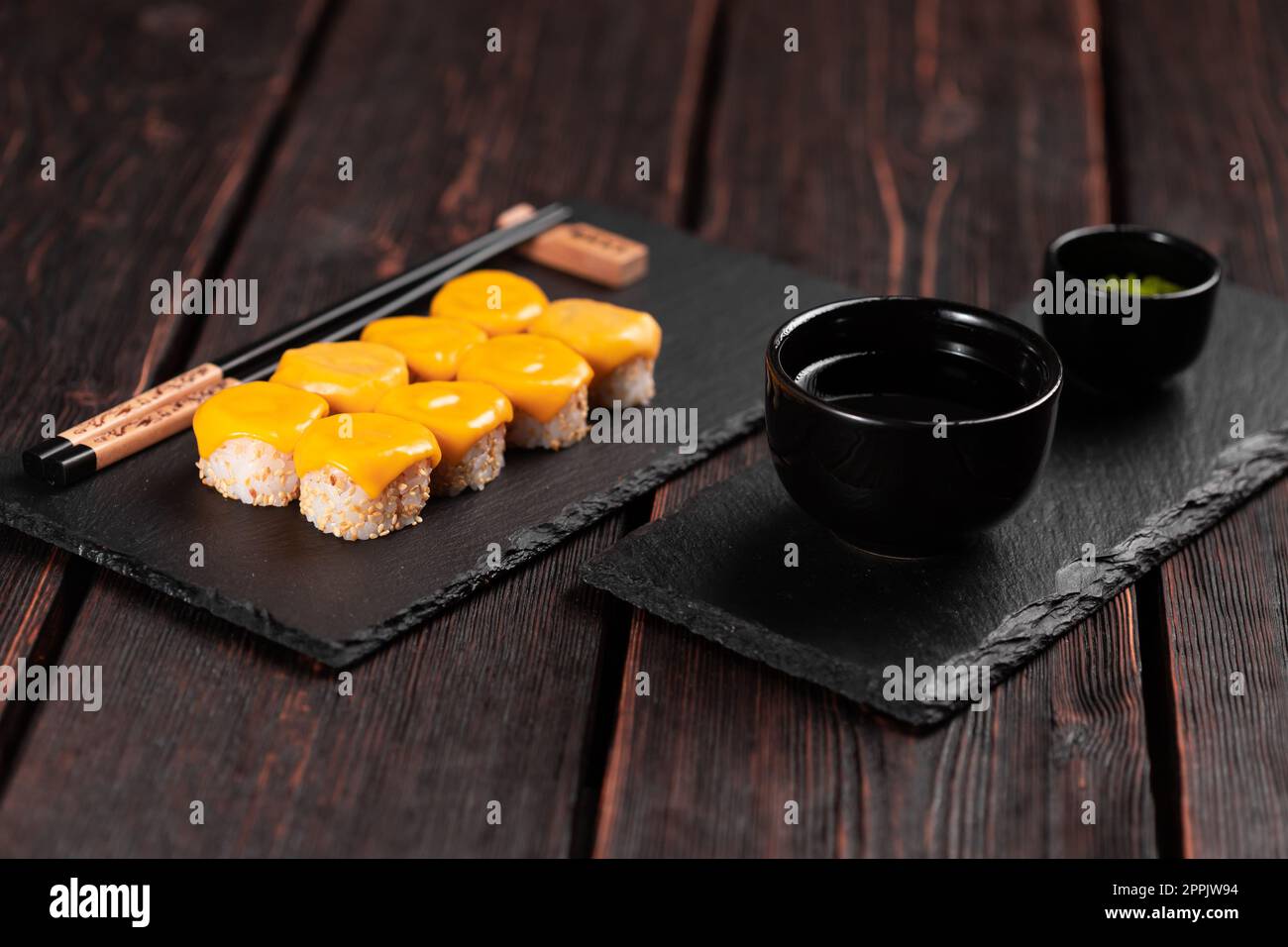 Sushi roll with cheese with chopsticks - asian Japanese food concept ...