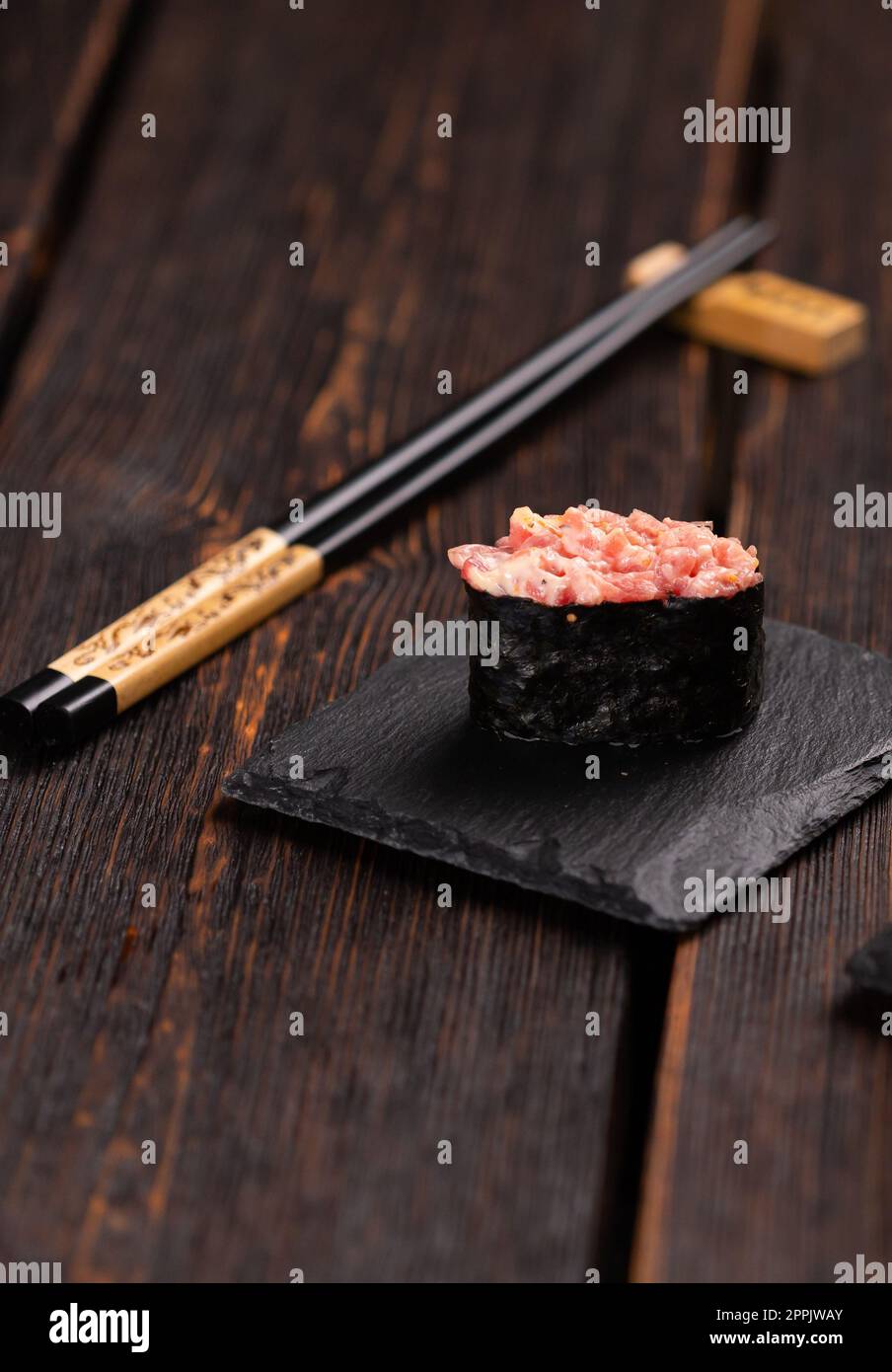 Gunkan Maki Sushi of fish salmon, scallop, perch, eel, shrimp and caviar on wooden table ...