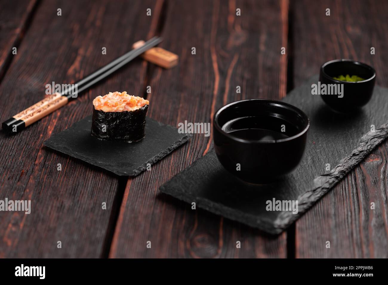 Gunkan Maki Sushi of fish salmon, scallop, perch, eel, shrimp and caviar on wooden table ...