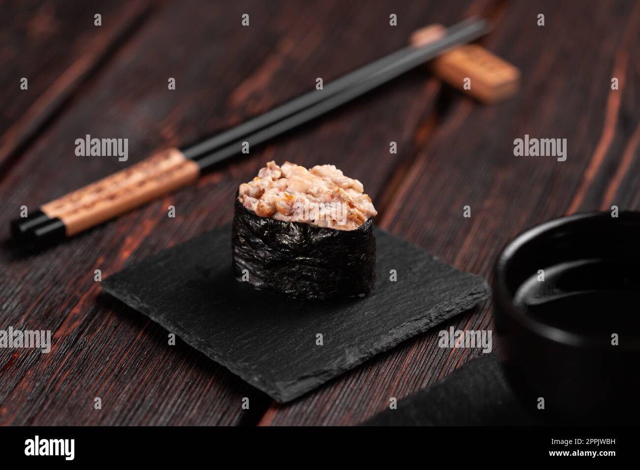 Gunkan Maki Sushi of fish salmon, scallop, perch, eel, shrimp and caviar on wooden table ...