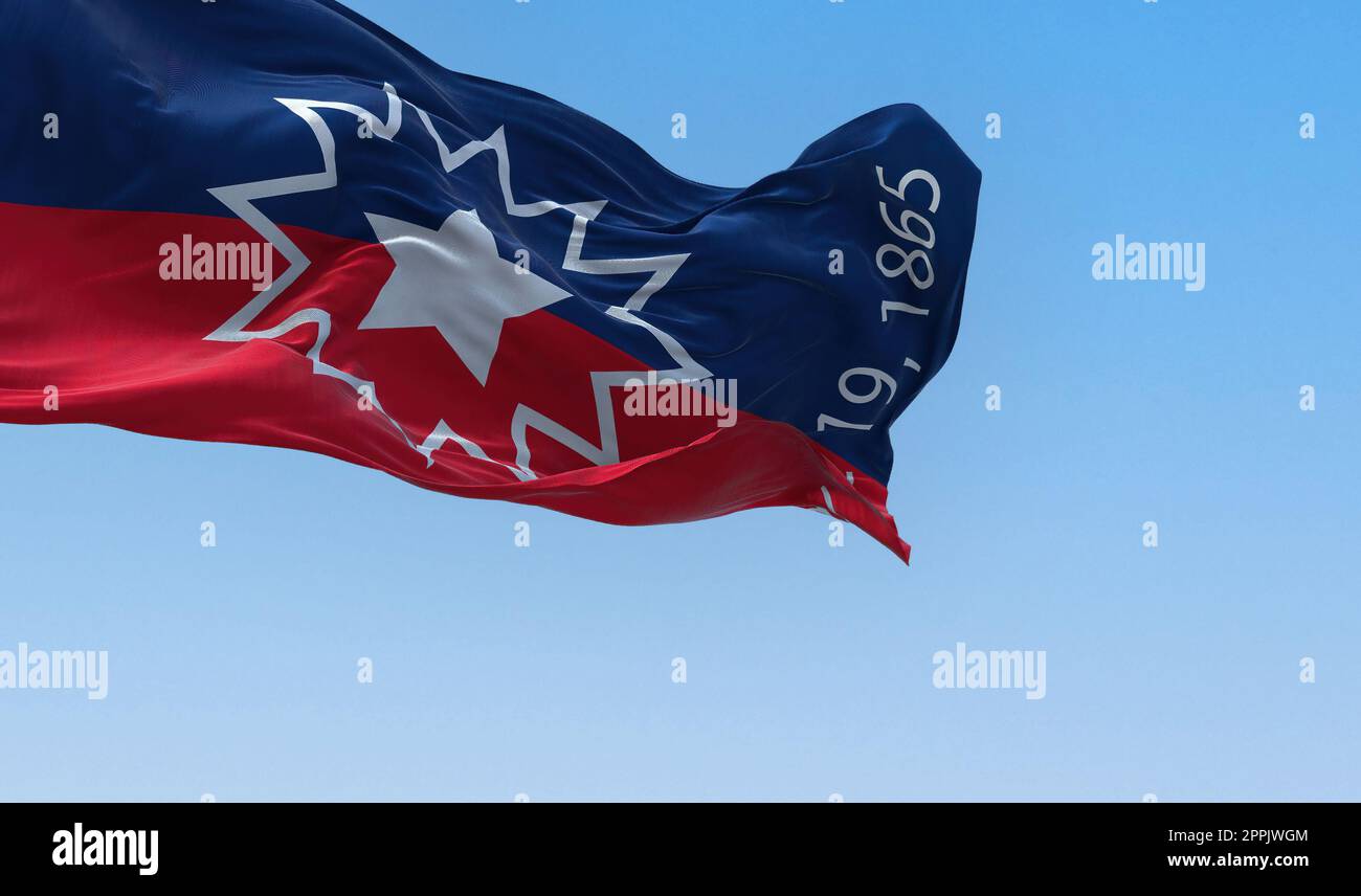 The Juneteenth flag waving in the wind Stock Photo - Alamy
