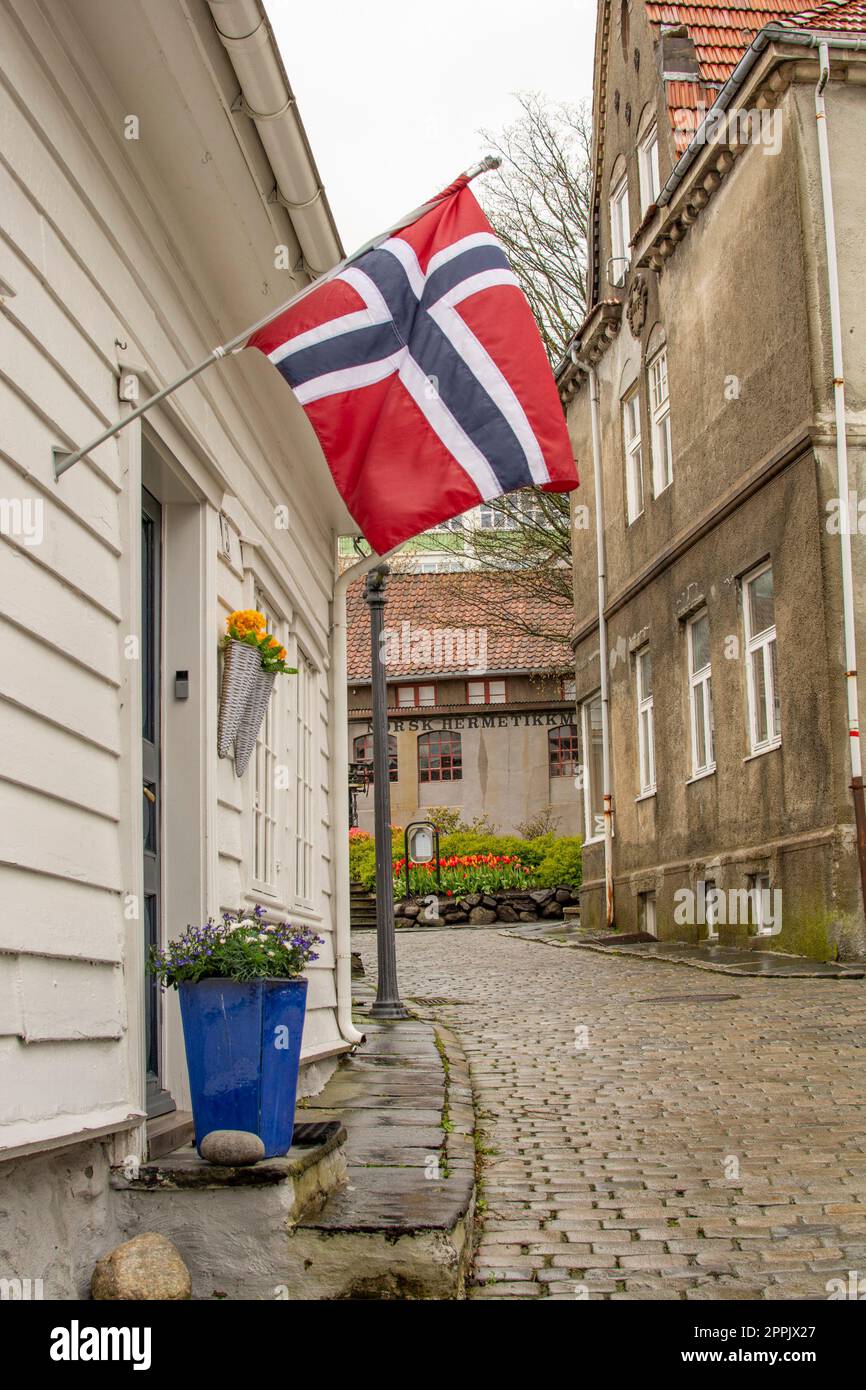 Norwegian patriotism, flag hanging on residential wooden house in the ...