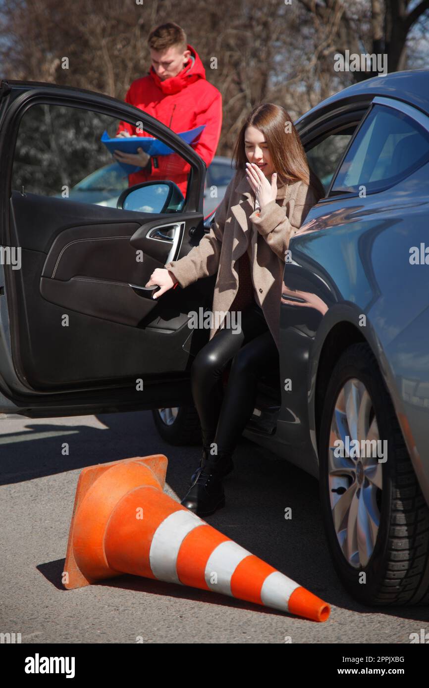 Driving instructor and woman student in examination car Stock Photo - Alamy
