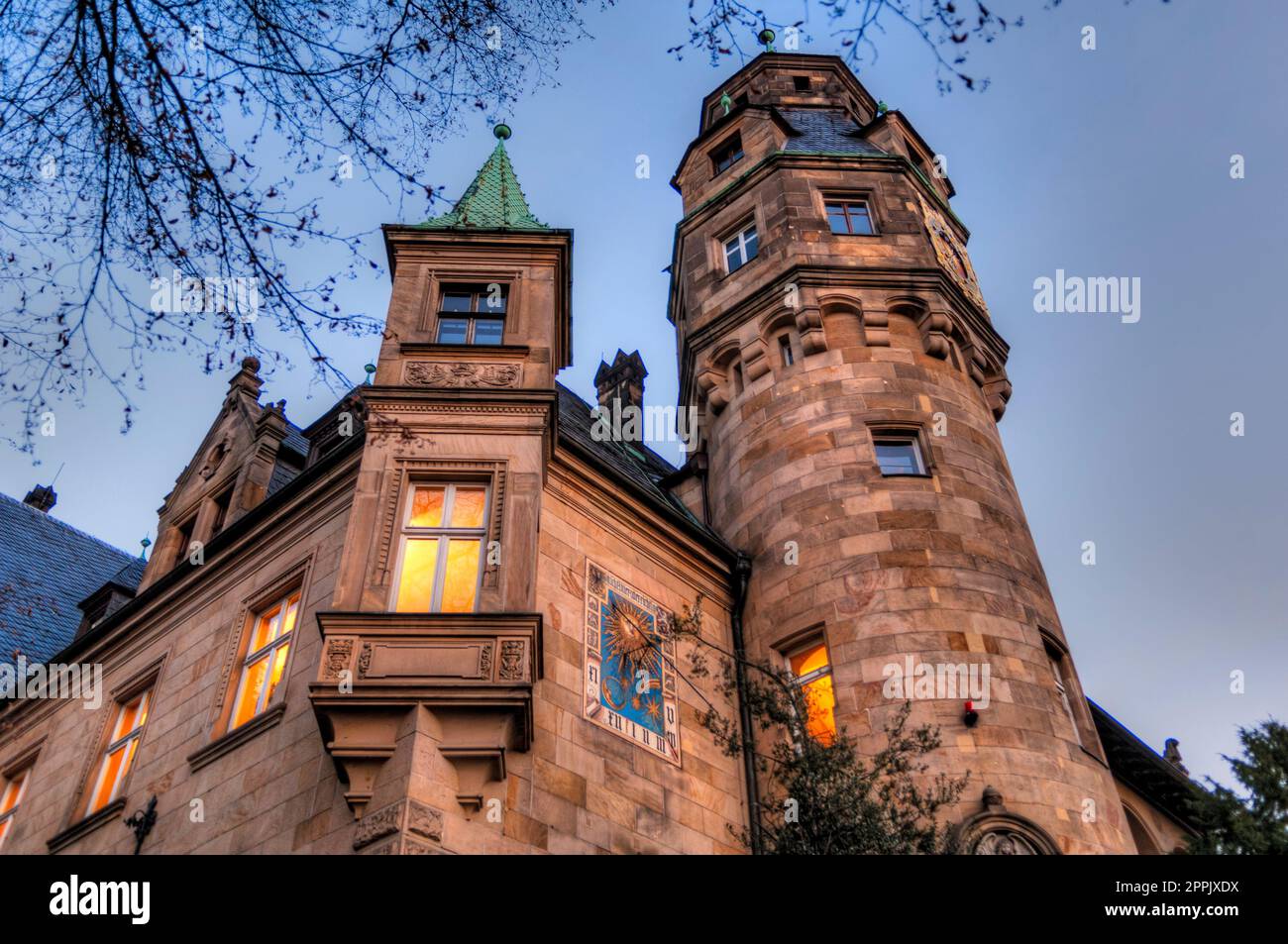 An enchanted castle with castle tower and illuminated windows in lower ...