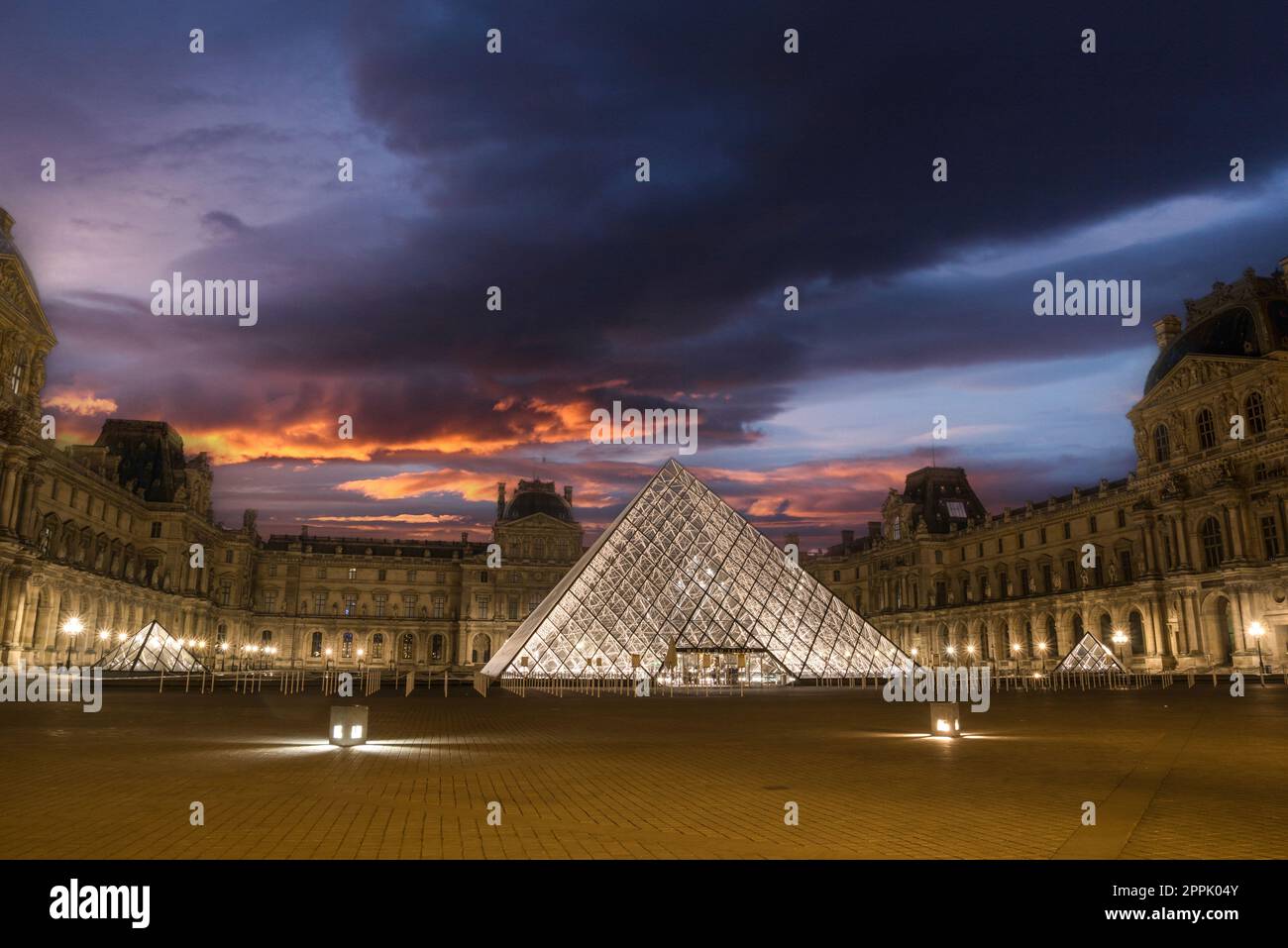 The famous Parisian Louvre Palace and its iconic glass pyramide in the ...