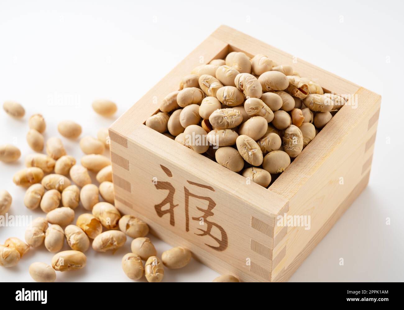 A wooden "fukumame" (lucky beans) bowl set against a white background ...