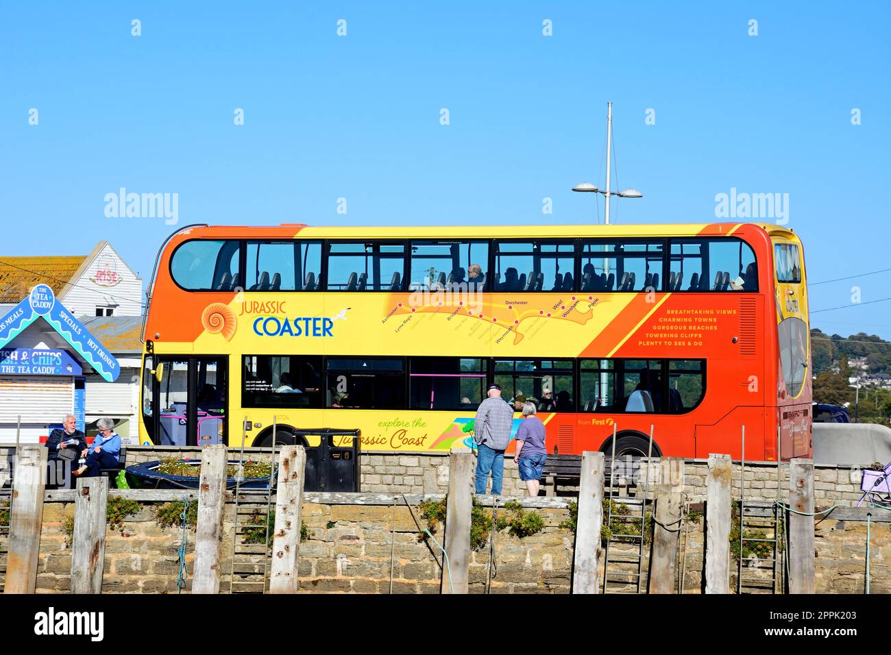 Tourists aboard a Jurassic Coaster bus in the harbour area, West Bay ...